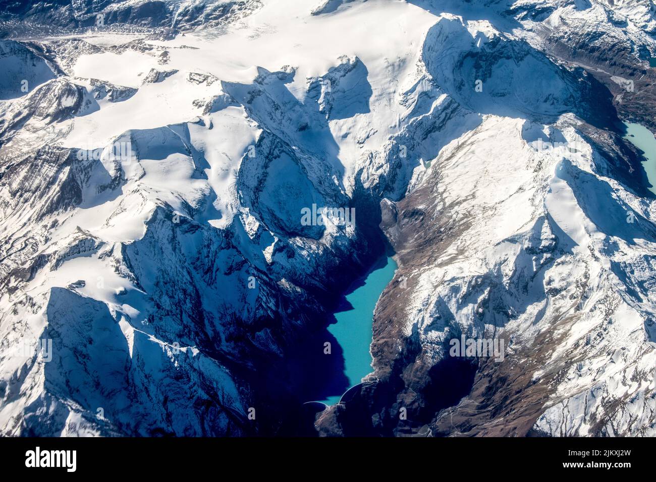 An aerial view of a river streaming through snowy mountain range Stock ...