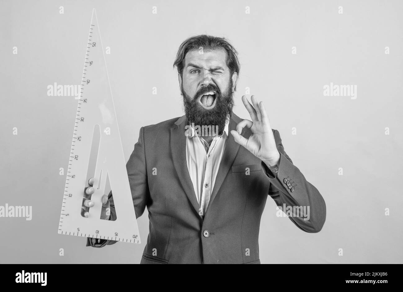 brutal unshaven guy university lecturer with math triangle ruler, study ...