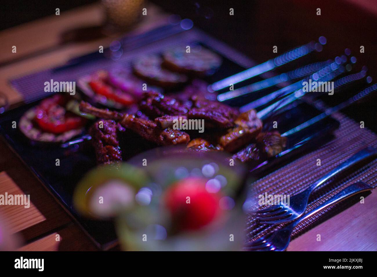 A plate of Chicken and beef BBQ with grilled tomatoes, potatoes and ...