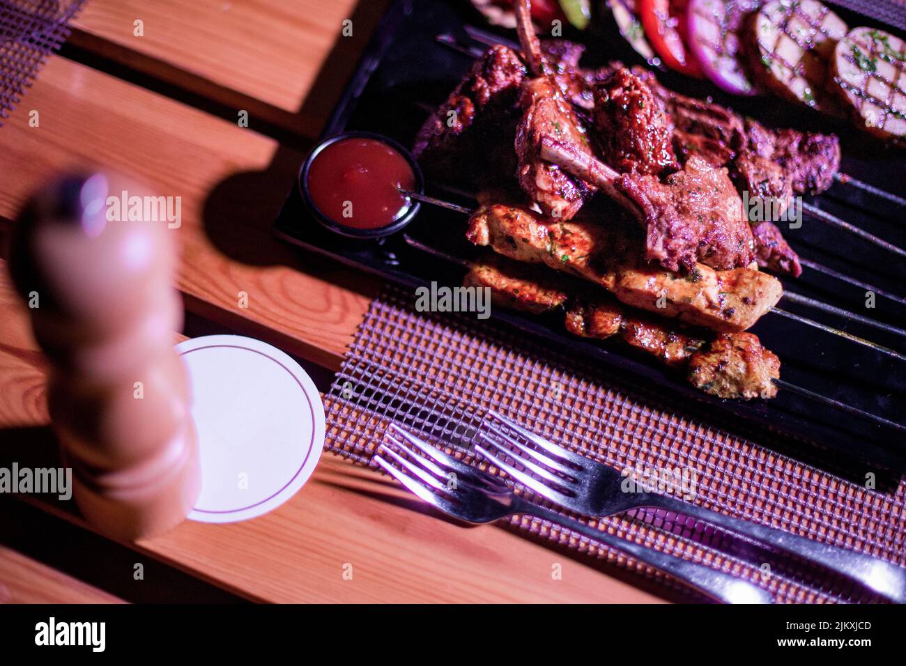 A plate of Chicken and beef BBQ with grilled tomatoes, potatoes and ...