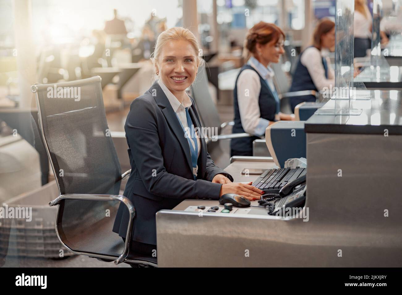 Passport control workers sitting at their workplace Stock Photo - Alamy