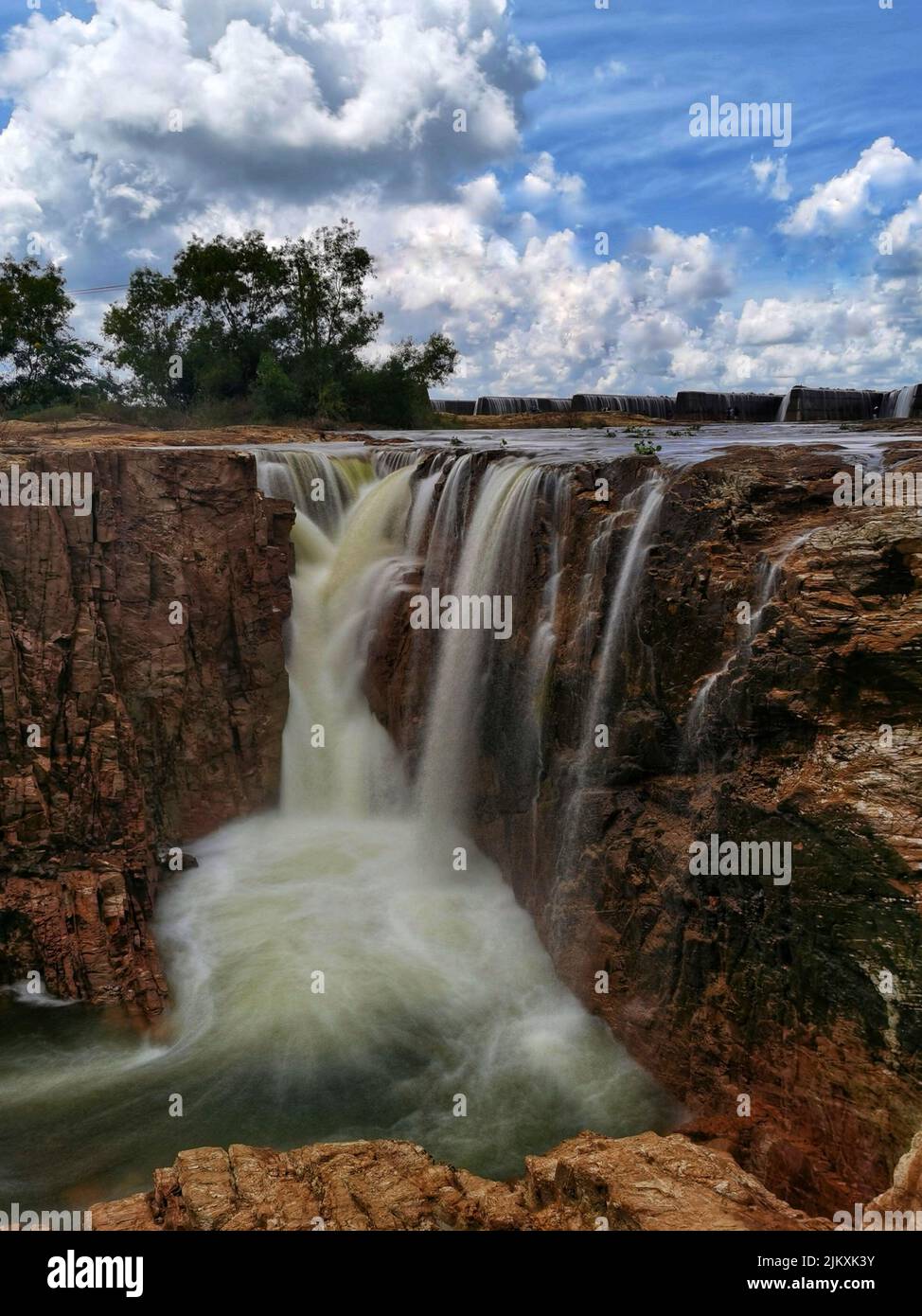 A beautiful shot of an artificial waterfall created by spilling water ...