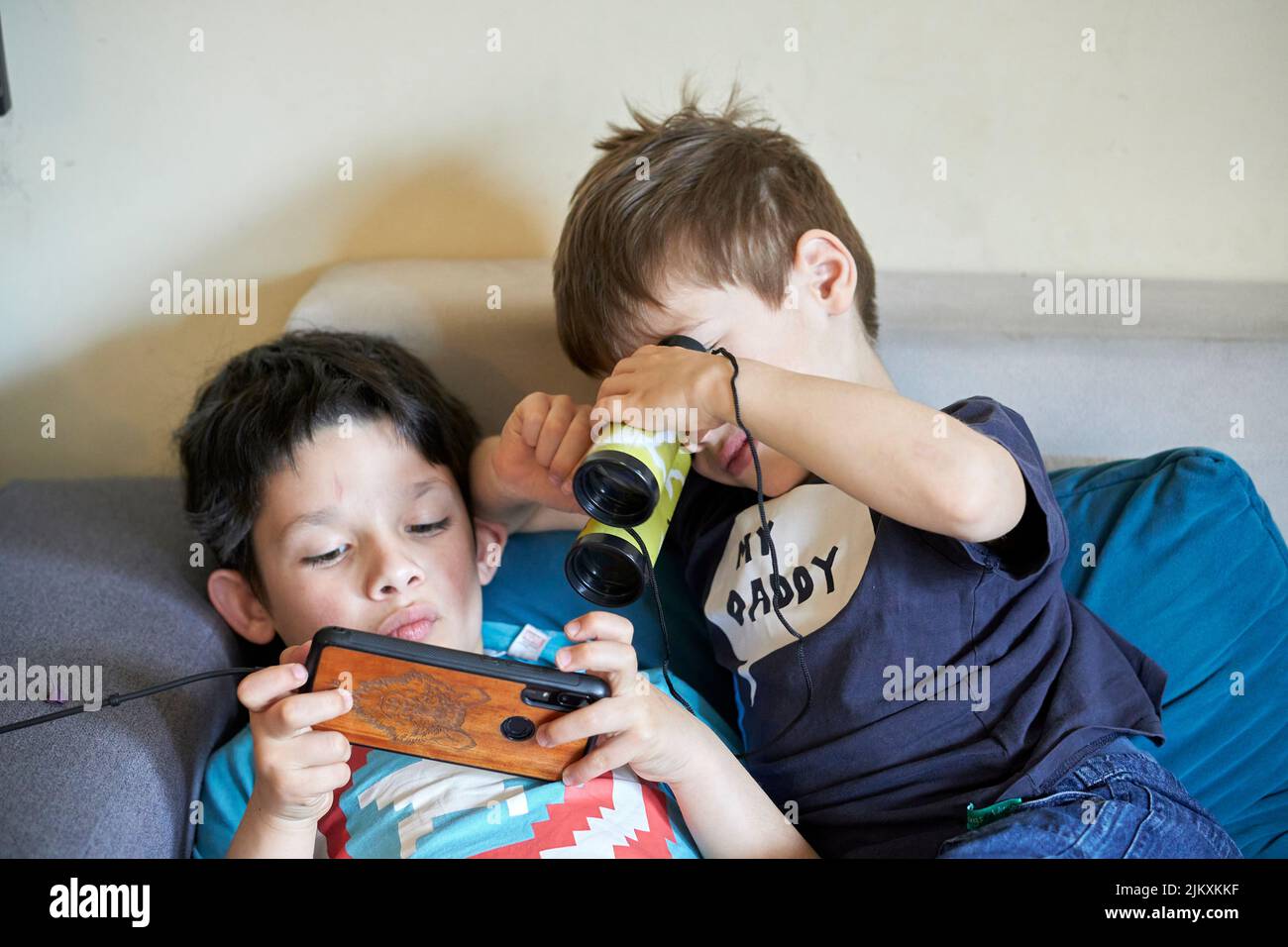 The two young Polish Caucasian boys playing with smartphone and ...