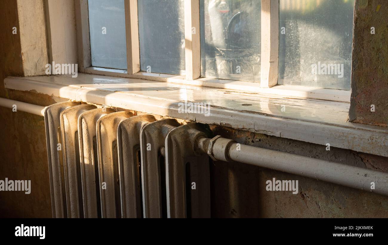 Old vintage house interior in sunset light. Cast iron radiator and ...