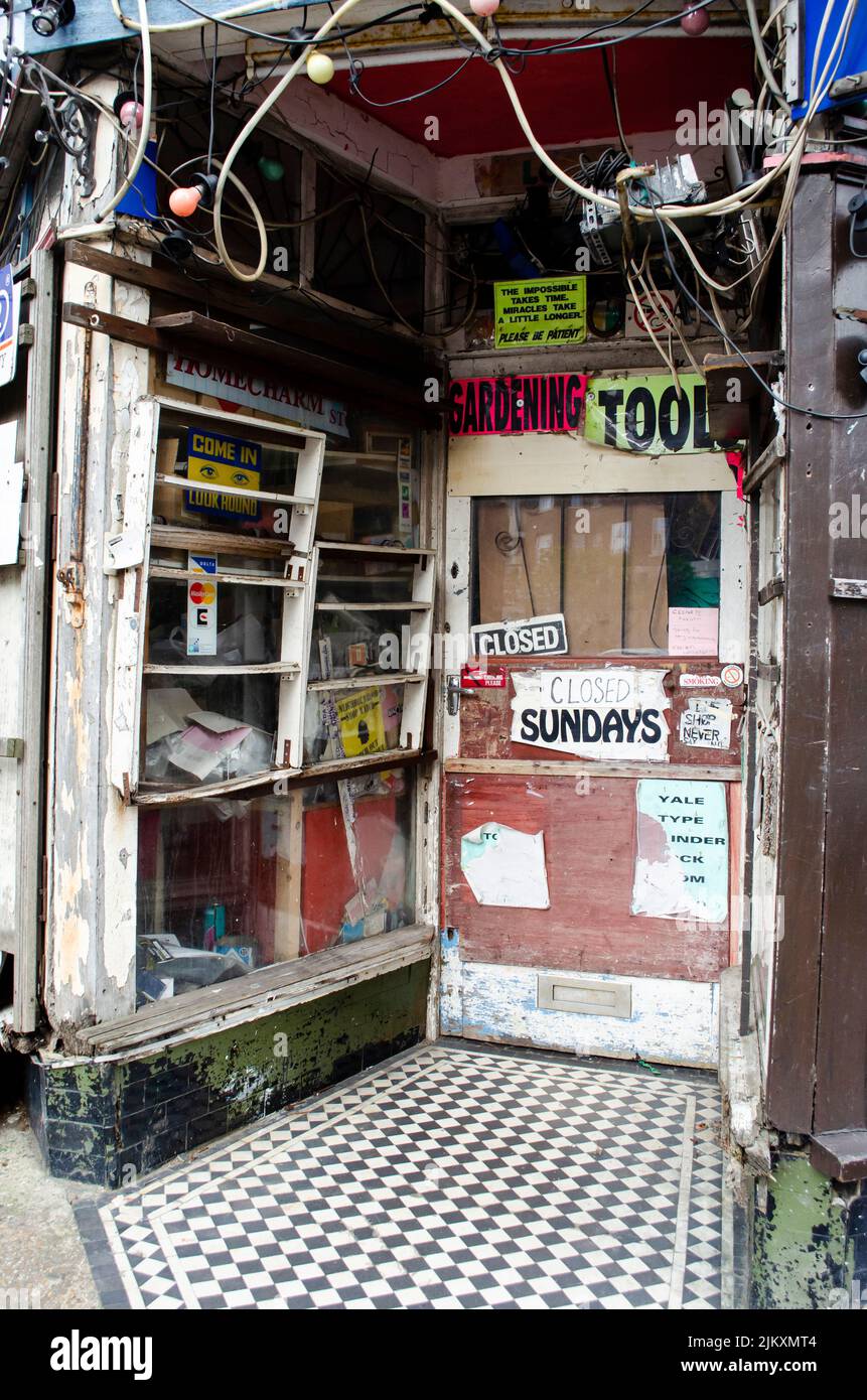 An old fashioned hardware store with multiple bright and torn signs ...