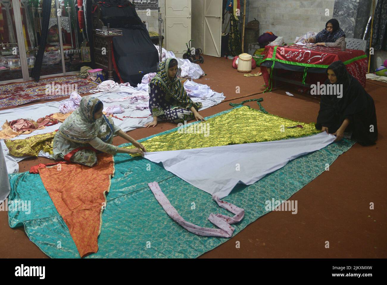 Pakistani shiite women busy in making Tazia Azadari items at Azakhana ...