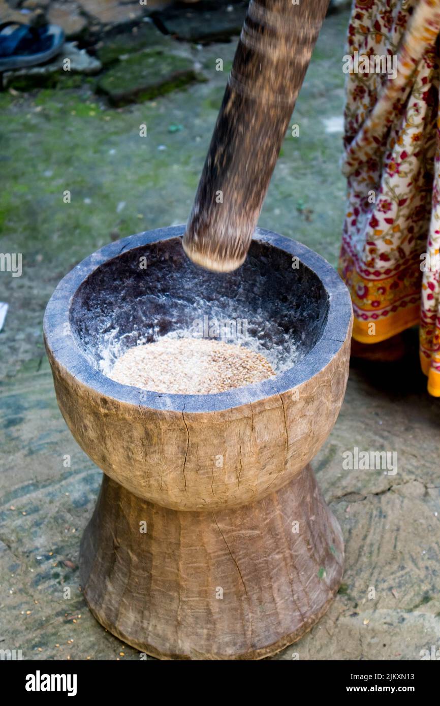 Pesting beans in a Ukhal musal (Mortal and Pestle) also known as Gail ...
