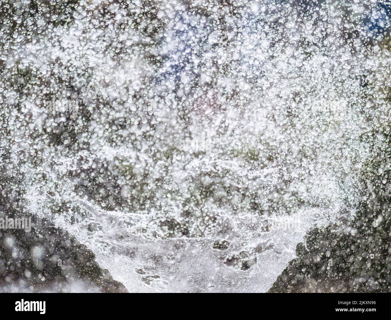 Water splashes from fountain on dark background. Natural texture of ...