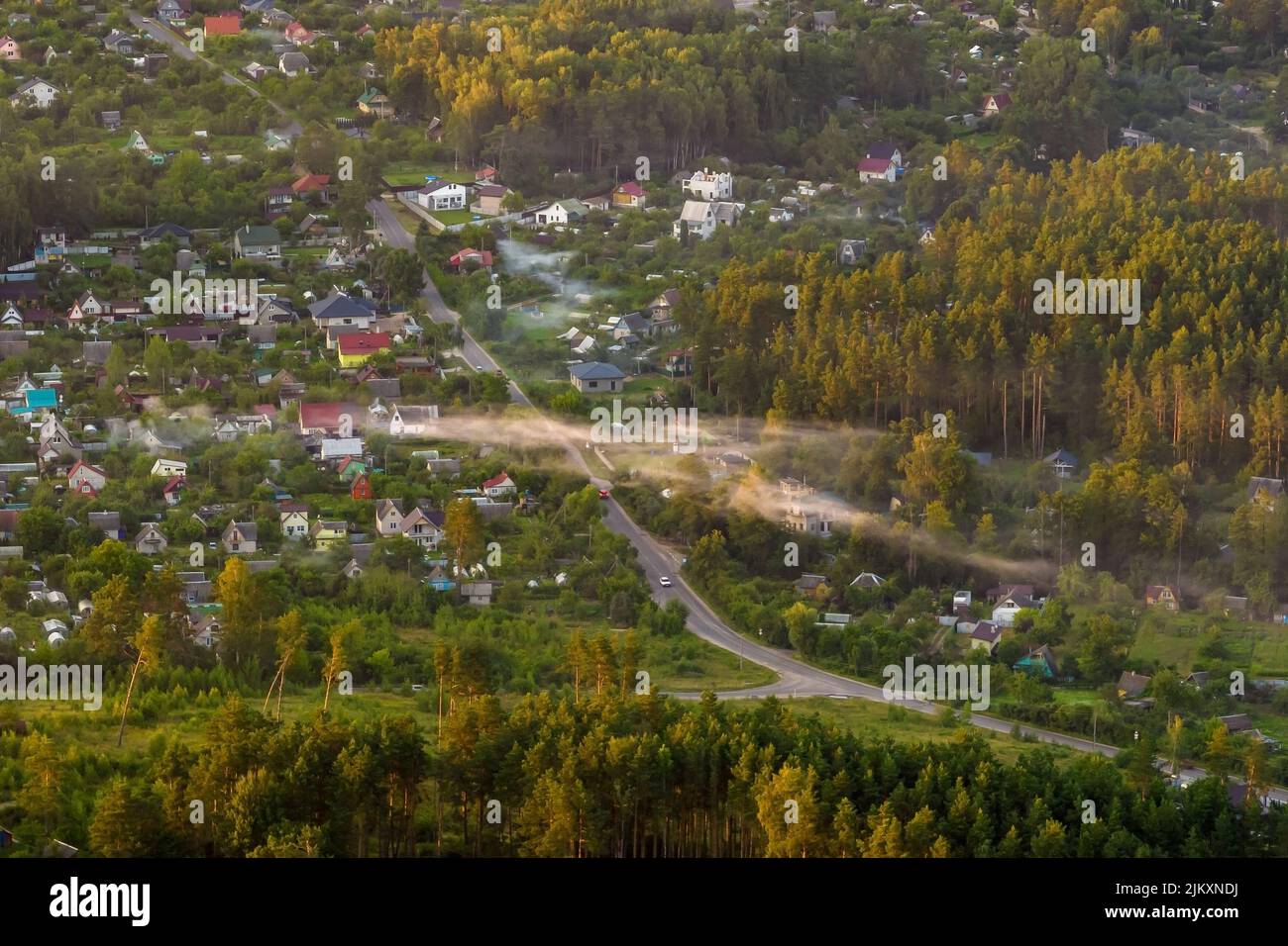 aerial panoramic view of green village with houses, barns and gravel ...