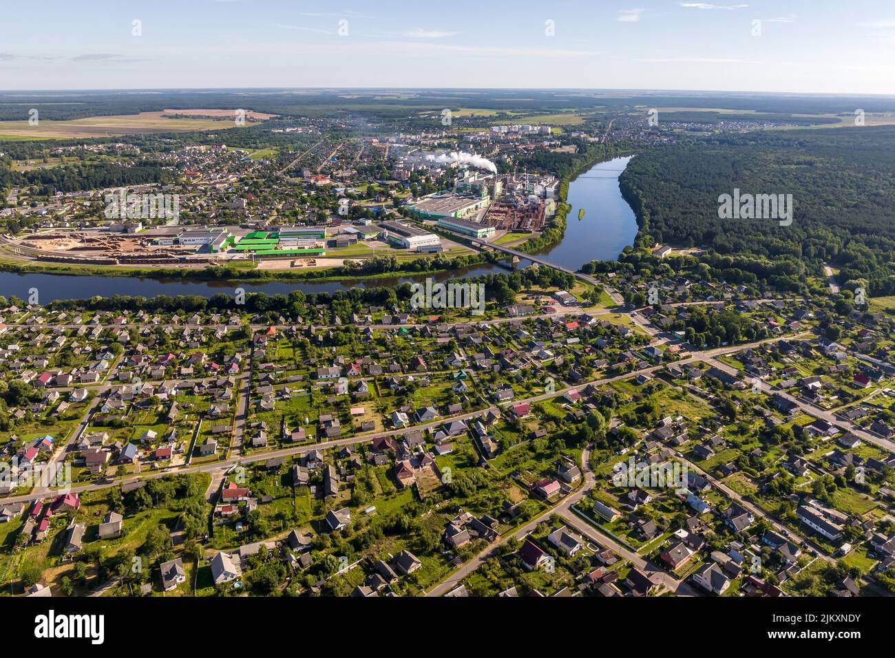 aerial panoramic view of green village with houses, barns and gravel ...