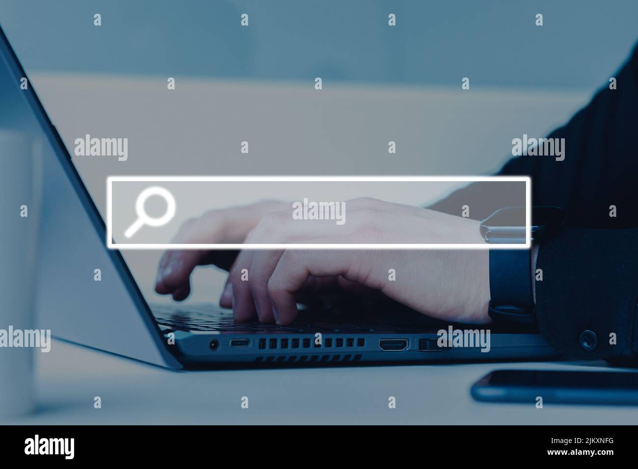 A male hand typing on a laptop in the office with a visual screen ...