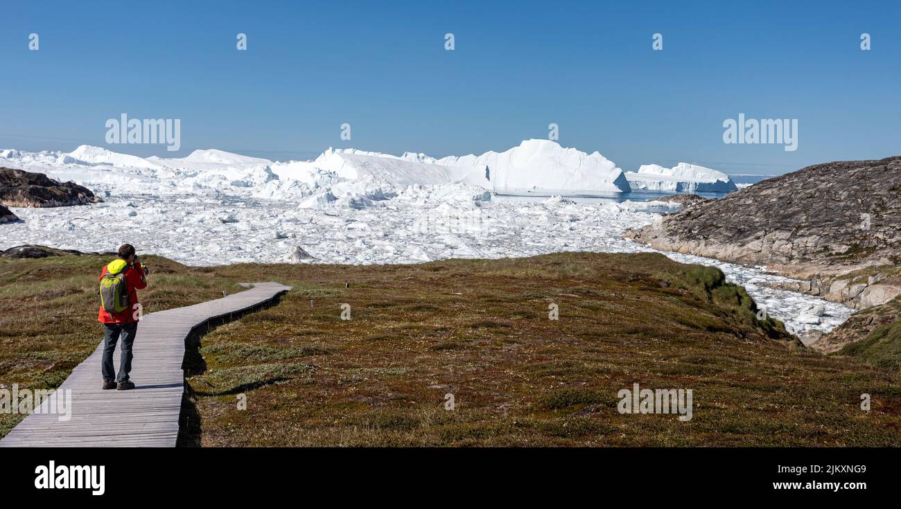 Wooden walkway through the arctic tundra leading to the Ilulissat ...