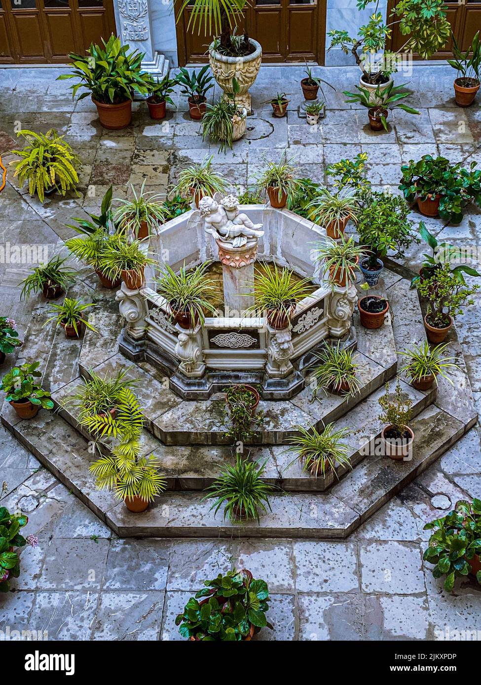 The vertical aerial shot of a house garden fountain design with ...