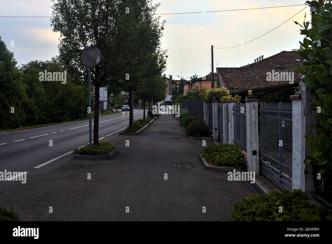 Pavement by the edge of a country road at sunset Stock Photo - Alamy