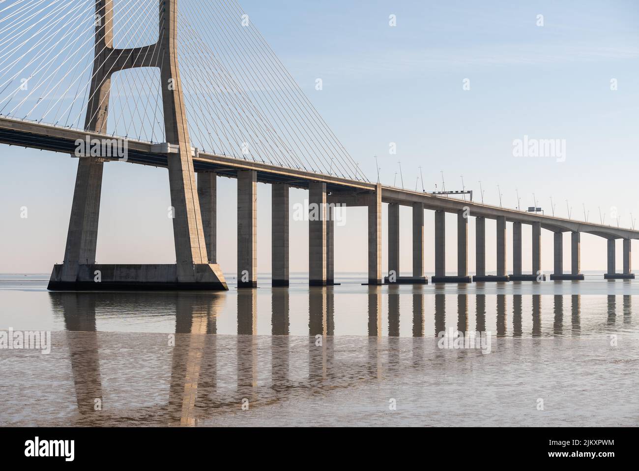 A landscape with low tide next to Vasco da Gama Bridge in Parque das ...