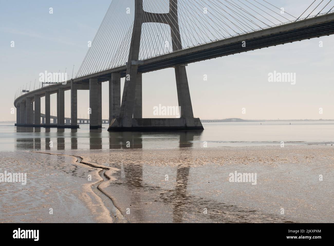 A landscape with low tide next to Vasco da Gama Bridge in Parque das ...