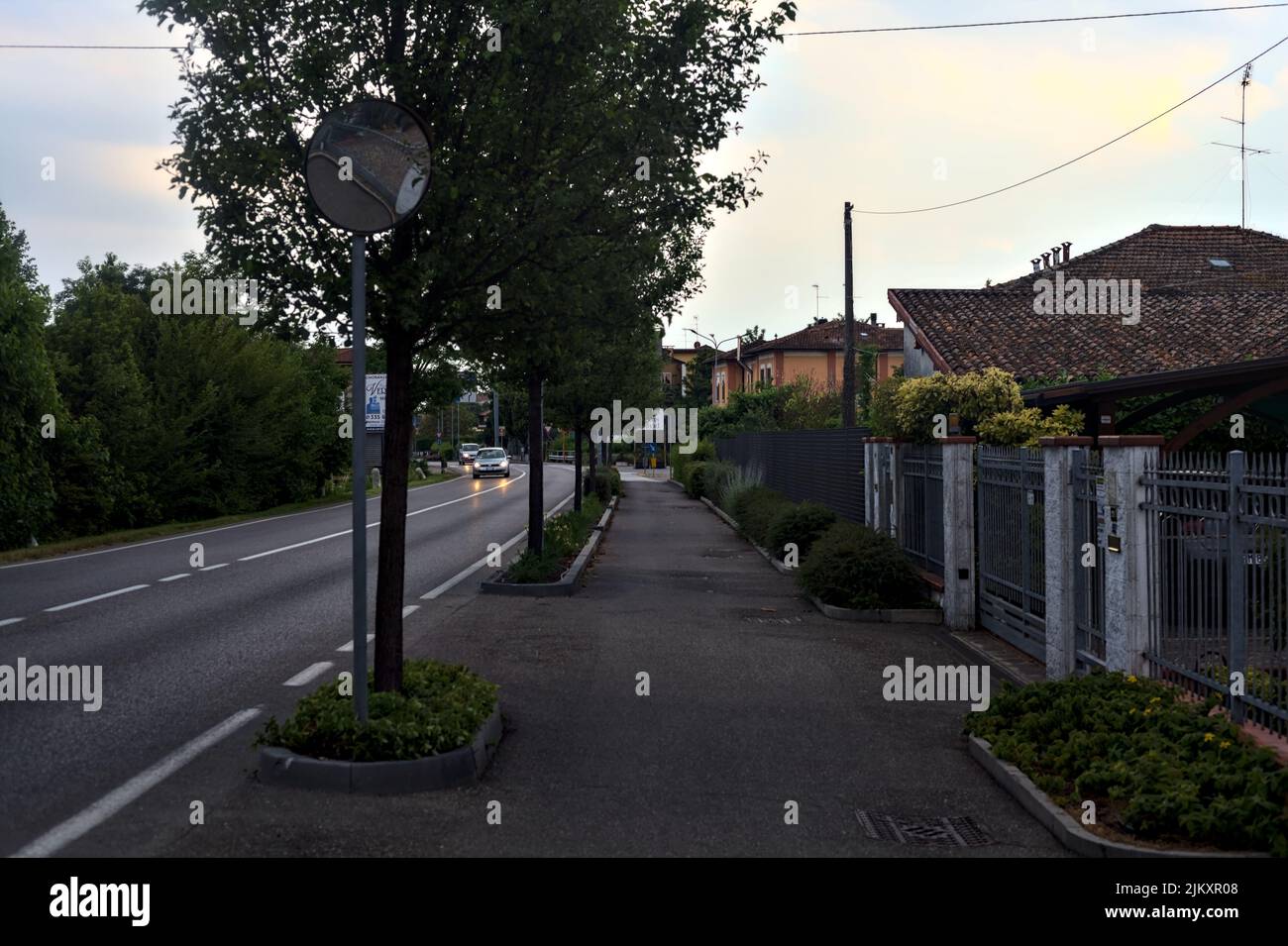 Pavement by the edge of a country road at sunset Stock Photo - Alamy