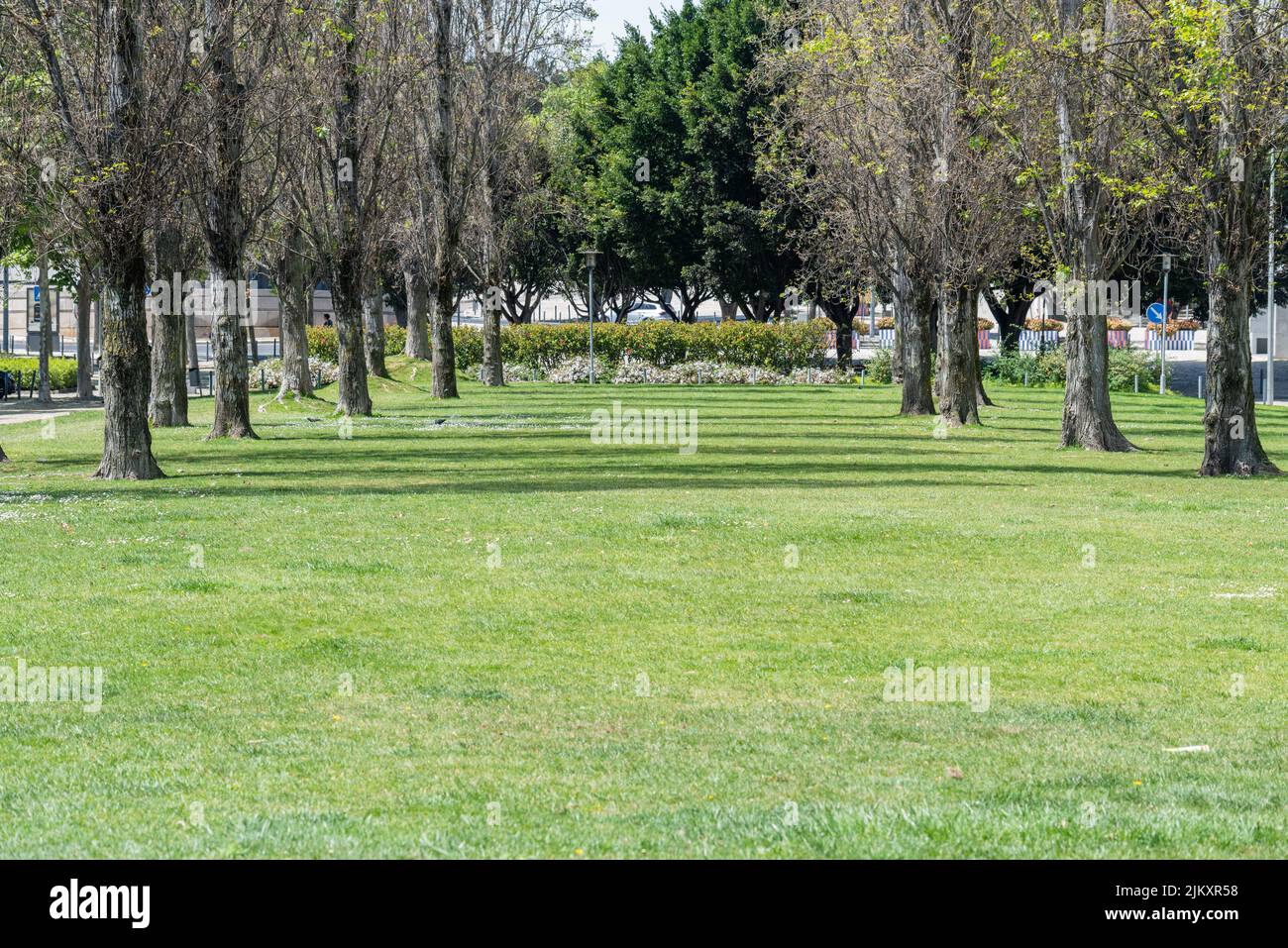 A walking path through a beautiful gree garden in Parque das Nacoes in ...
