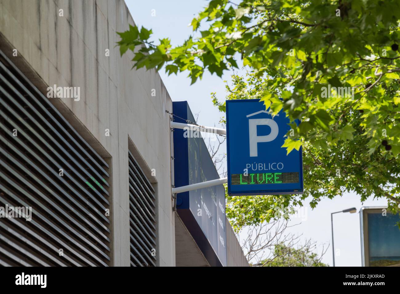 The illuminated parking sign outside, the parking garage structure ...