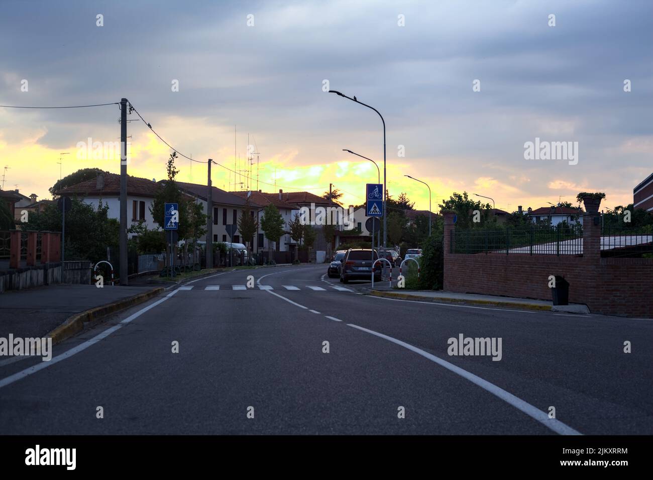 Road in the outskirt of an italian town at sunset Stock Photo - Alamy