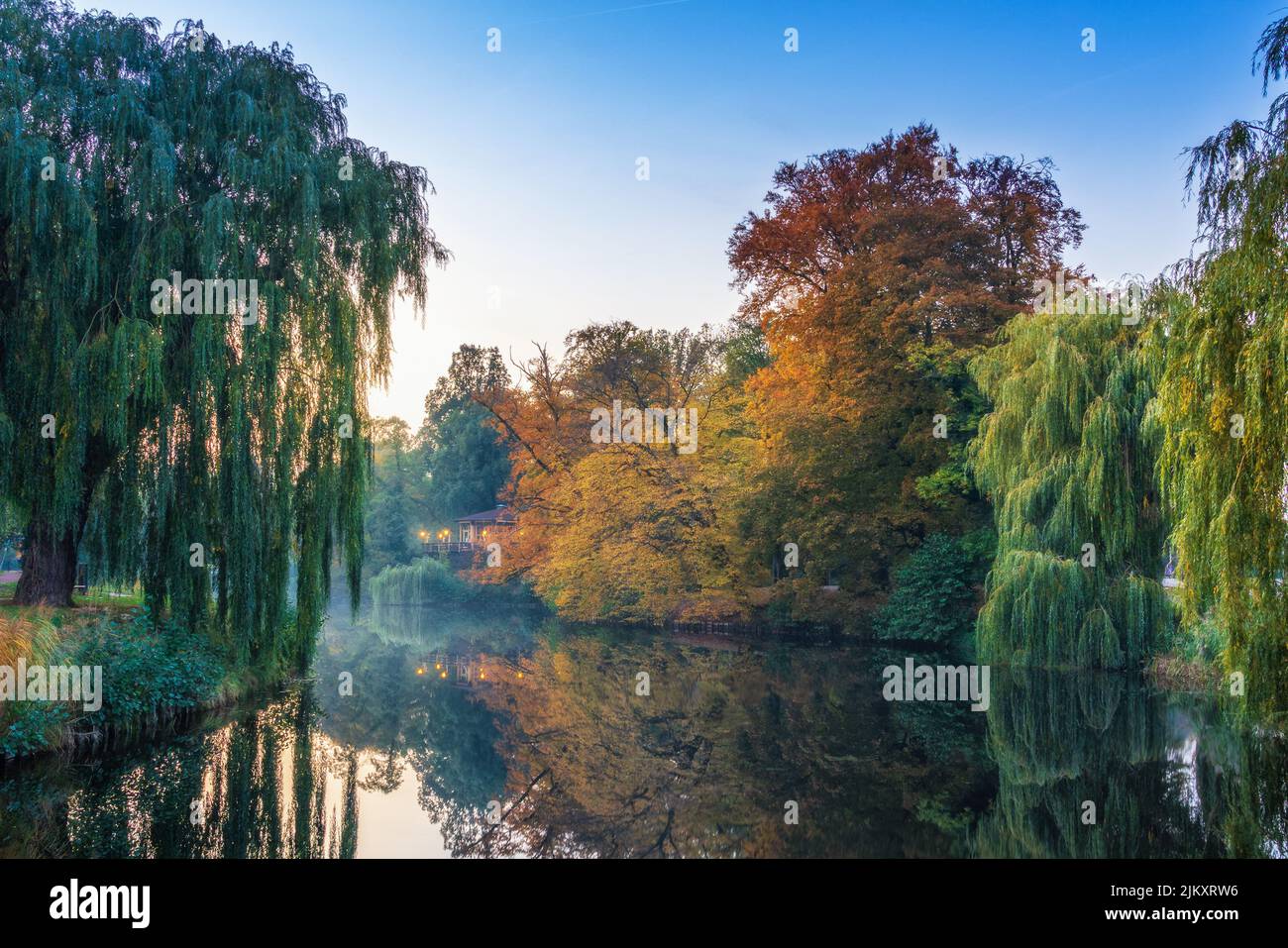 The beautiful view of the autumn park with colorful trees and the river ...