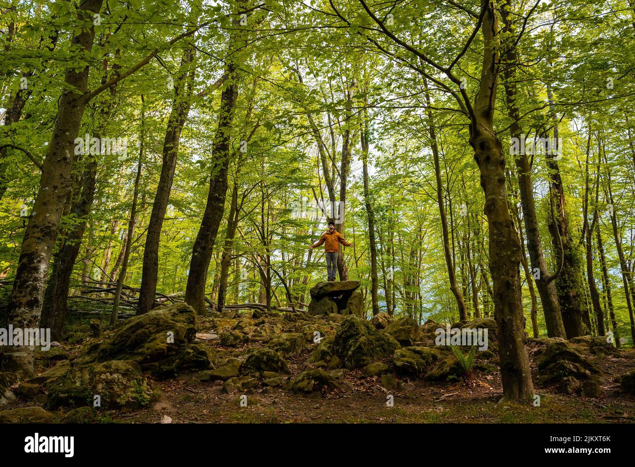 A man at the Aitzetako Txabala Dolmen in the Basque Country. Errenteria ...