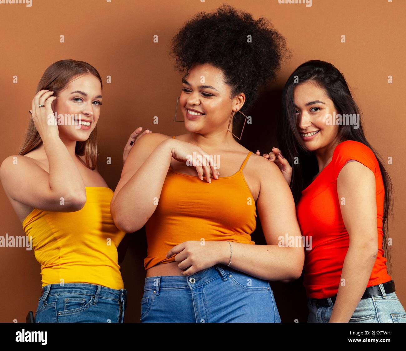 young pretty african and caucasian women posing cheerful together on ...