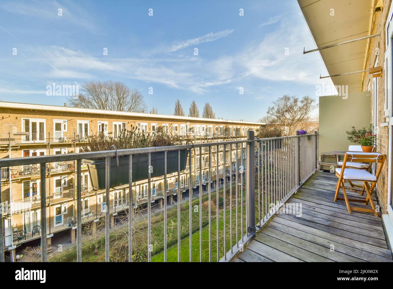 Front view of buildings and cars with bicycles from small balcony with ...