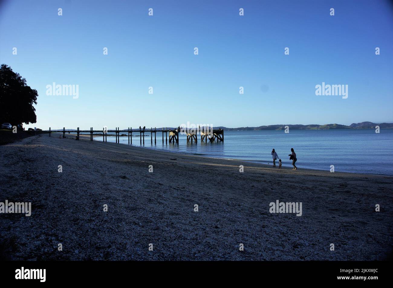 A scenic view of a family enjoying the beach at Magazine Bay Stock ...