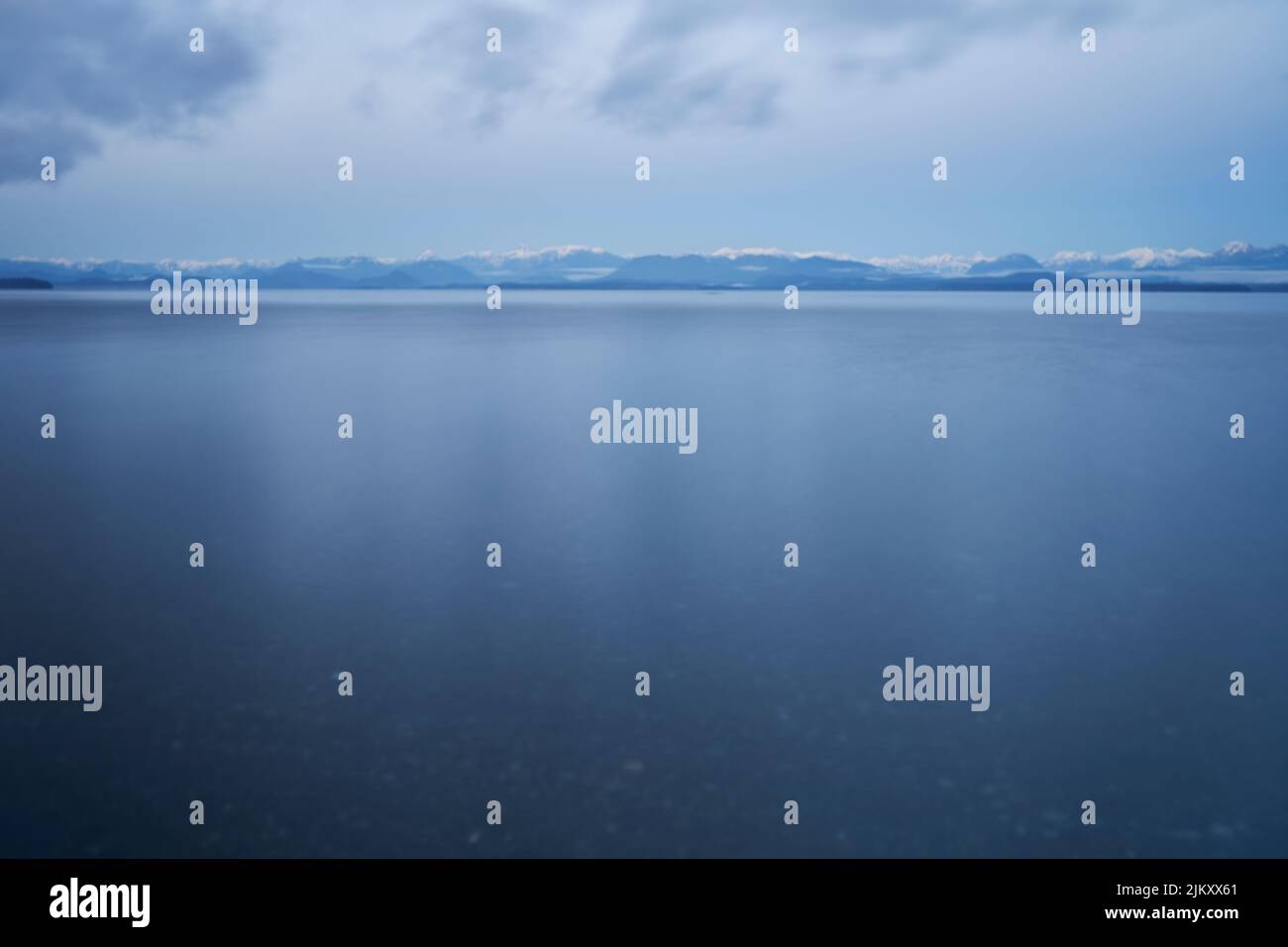 Time exposure view looking across the calm blue ocean to the distant ...