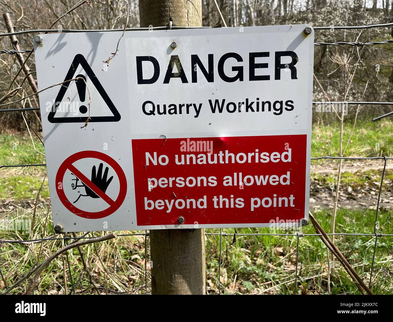 A Quarry danger, no unauthorized persons beyond this point sign fence ...