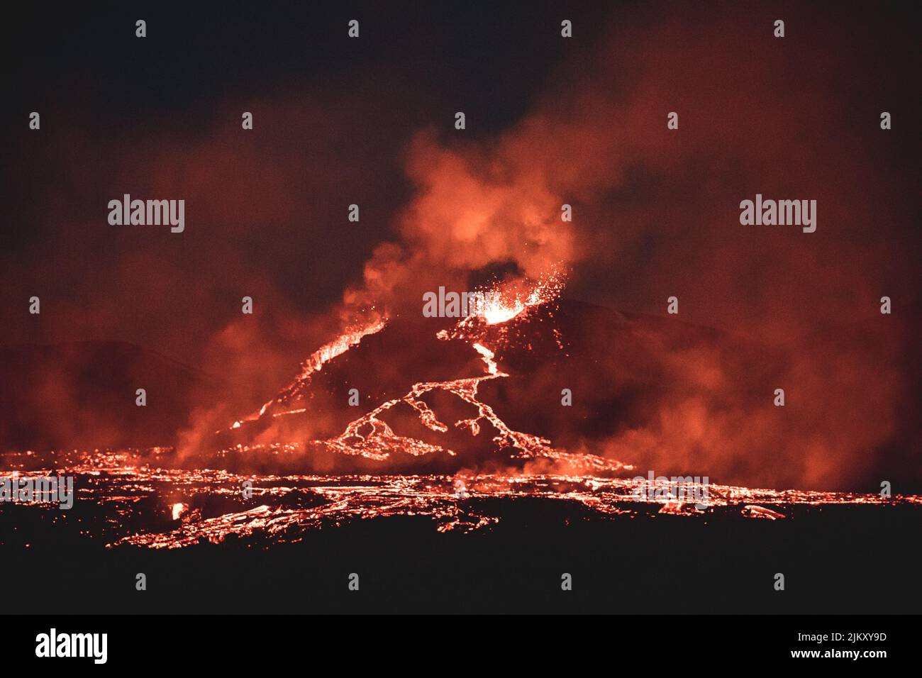 A night view of a volcano eruption in Iceland. fiery rivers flowing ...