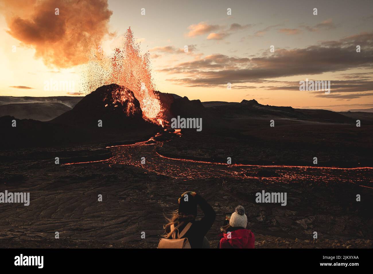 A evening view of the volcano eruption in Iceland. People are watching ...