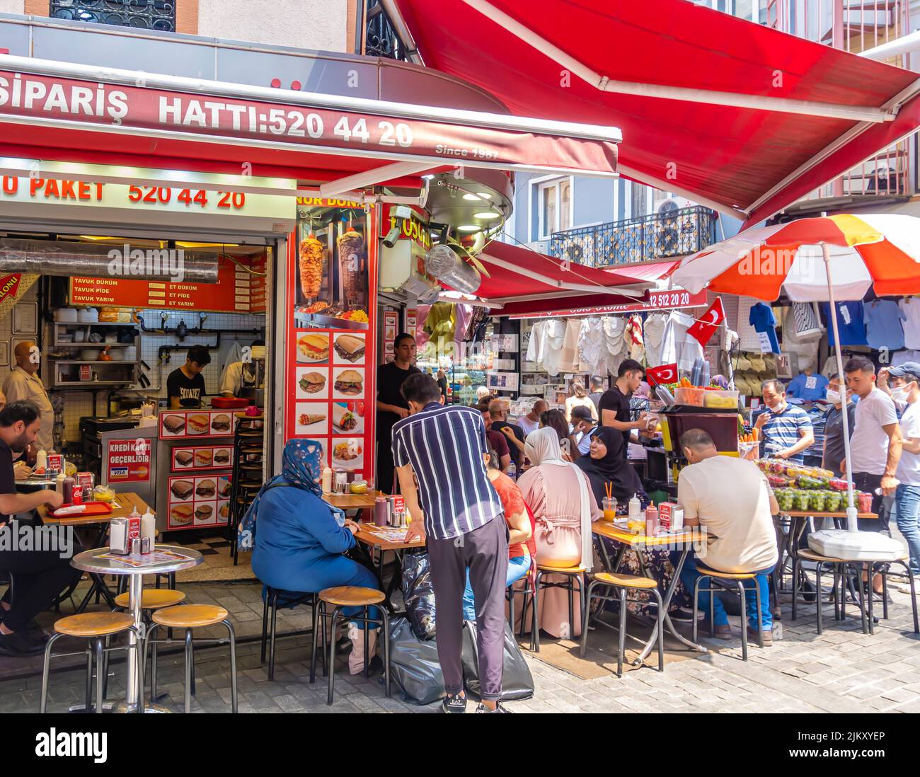 Fast food kiosk, cafe, and stand with visitors.Outdoor fast-food busy ...