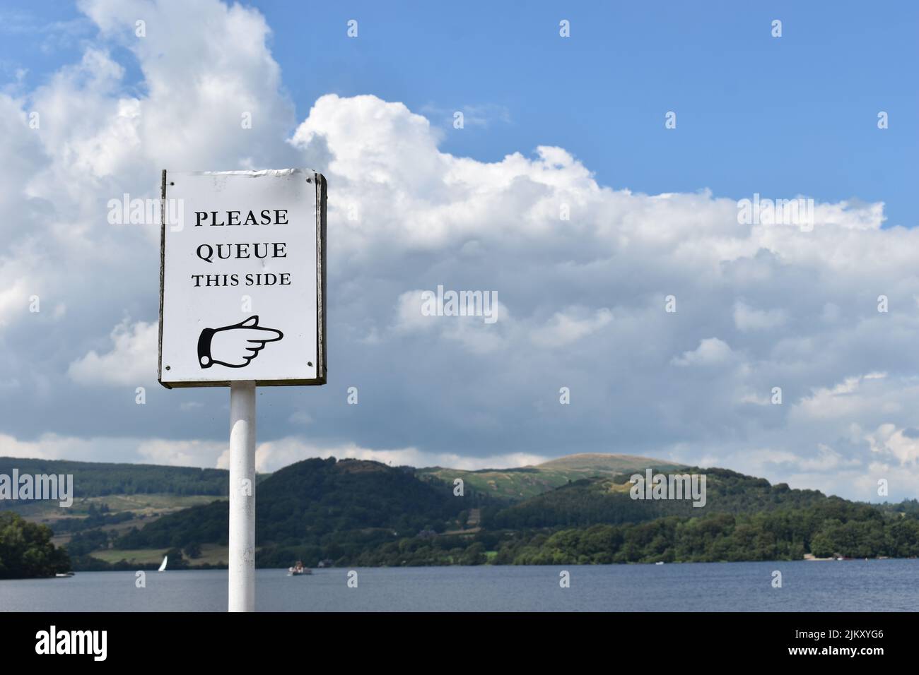 Notice: "Please queue this side" with copy space Stock Photo - Alamy