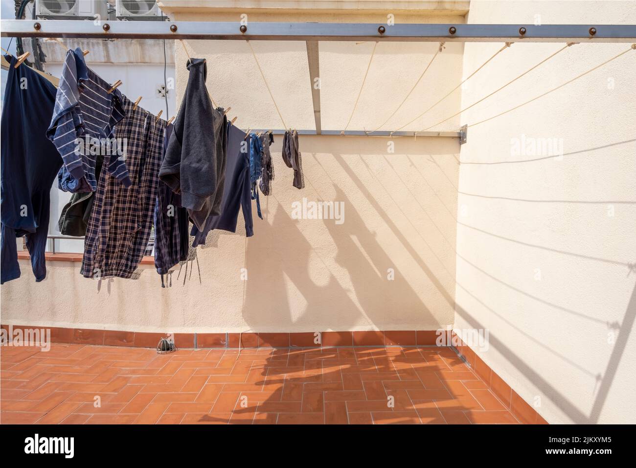 clothes hanging in the sun on a terrace Stock Photo - Alamy