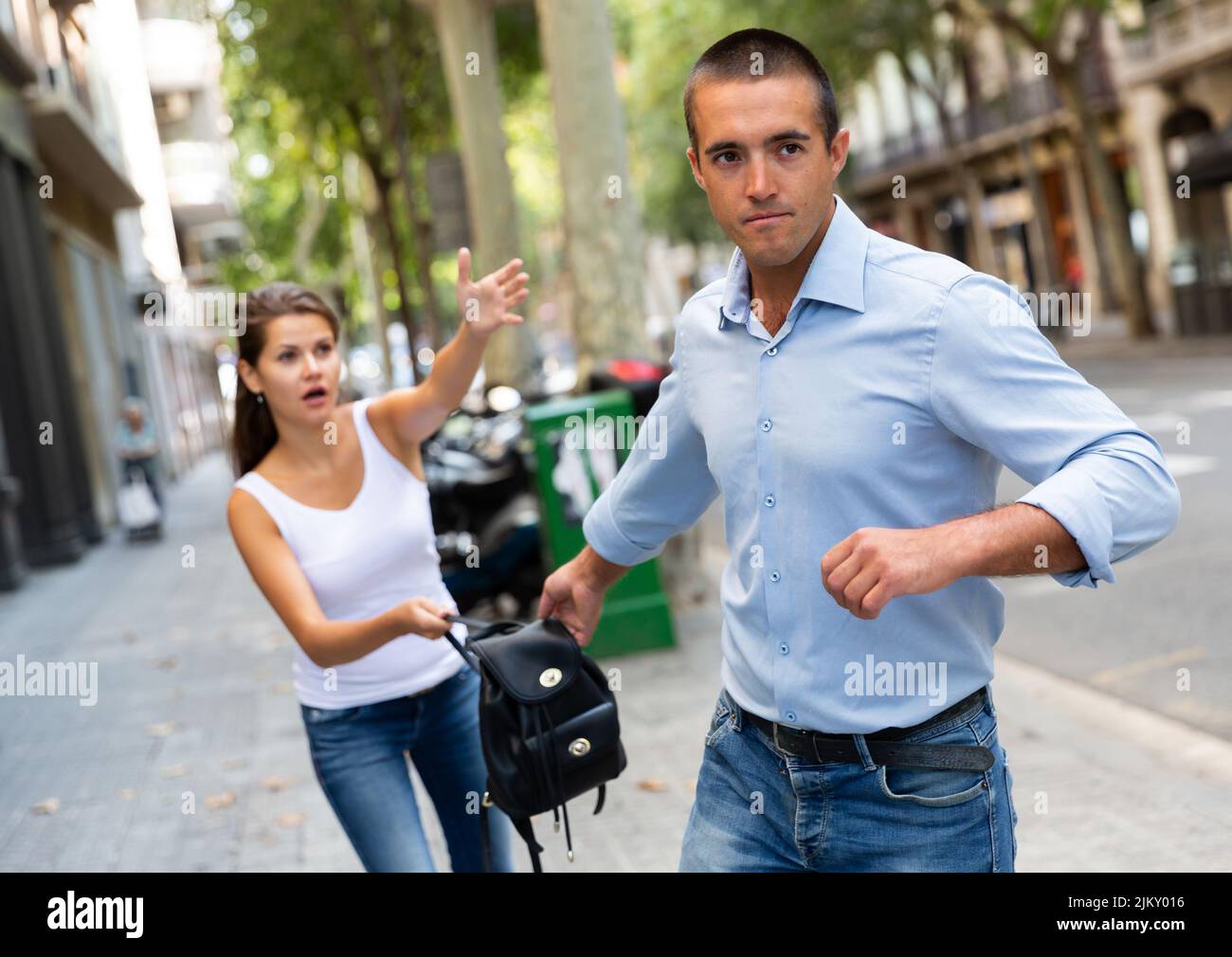 Street robbery pulling woman backpack Stock Photo - Alamy