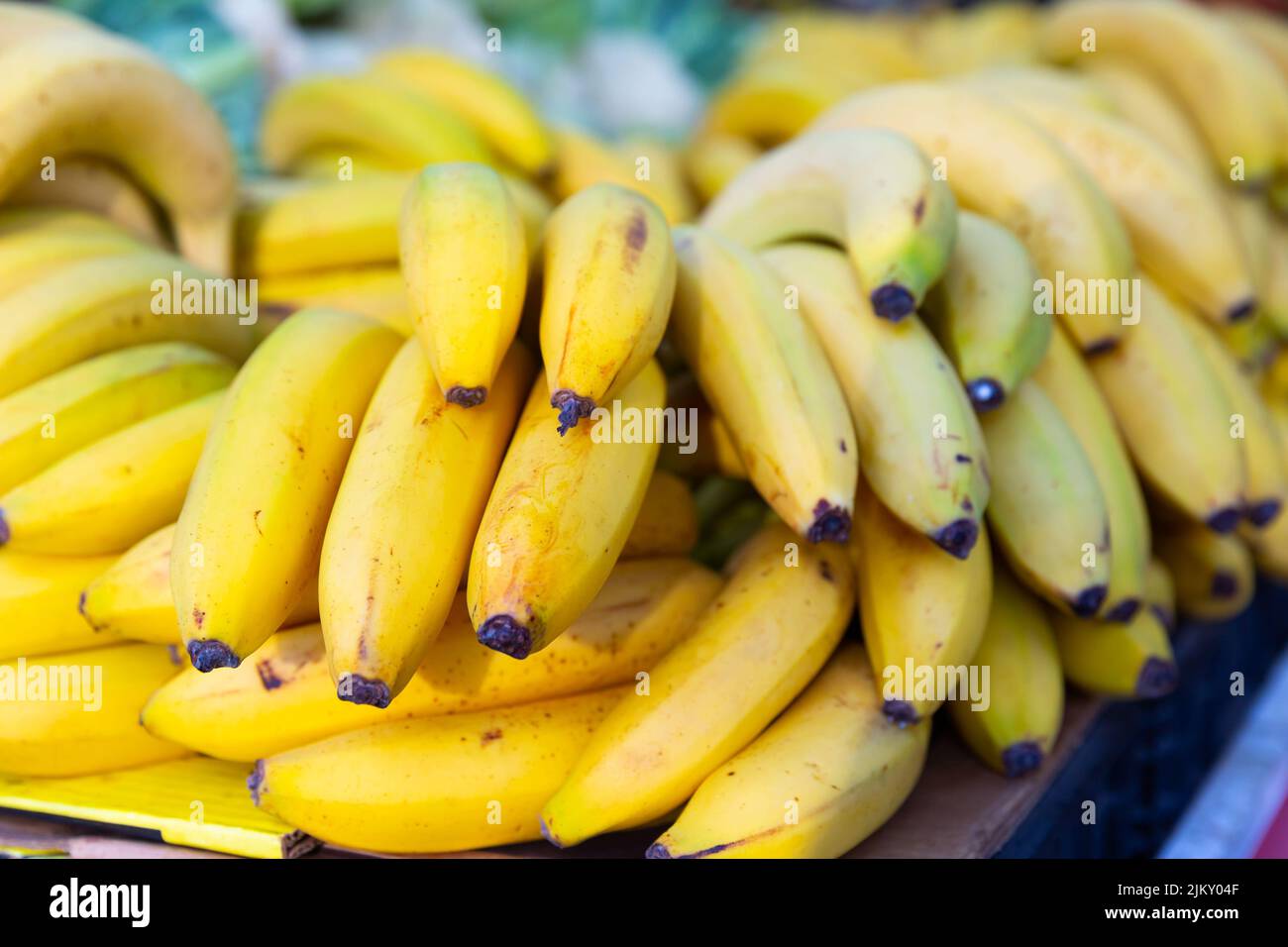 close up of mature bananas on counter in marketplace Stock Photo - Alamy