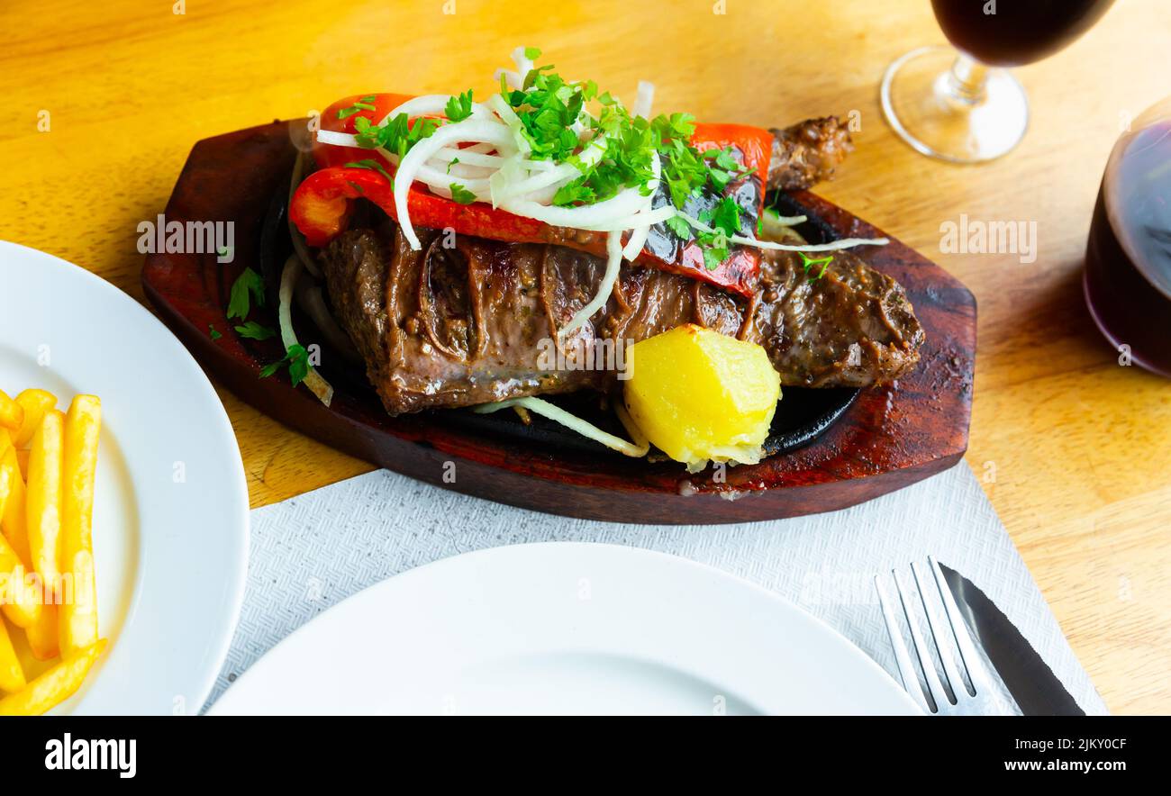 Grilled beef chop dinner served with vegetable garnish Stock Photo - Alamy