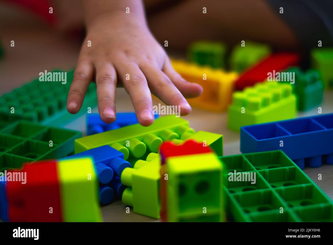 little girl playing with toys at home, legos type toys Stock Photo - Alamy