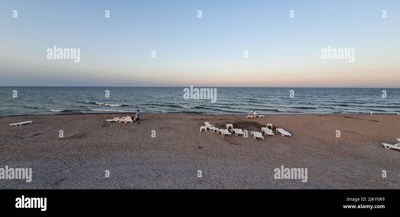 The sea beach panoramic shot with a group of white beach benches Stock ...