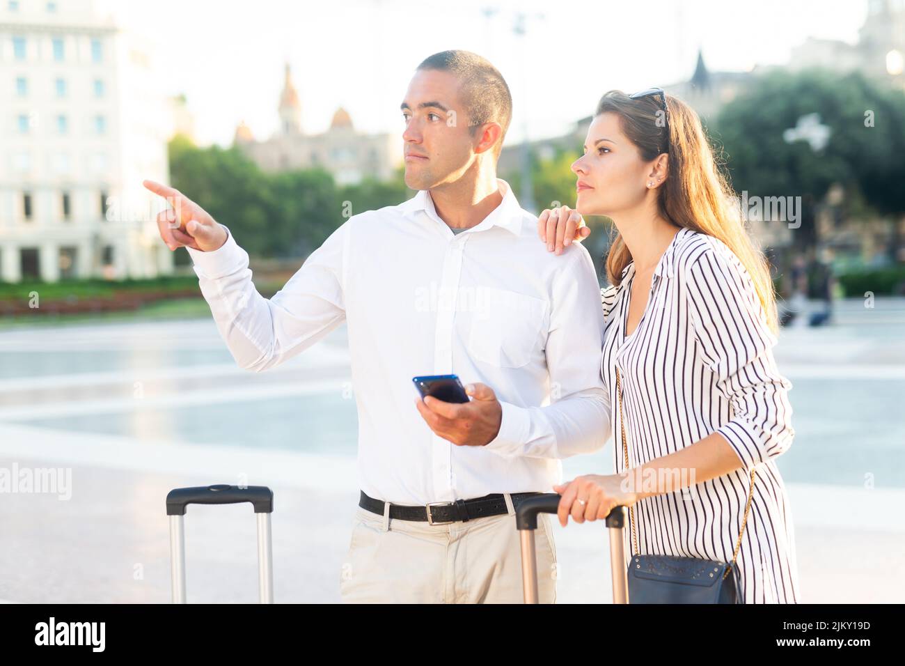 Smiling man and woman visiting city attractions on vacation Stock Photo ...