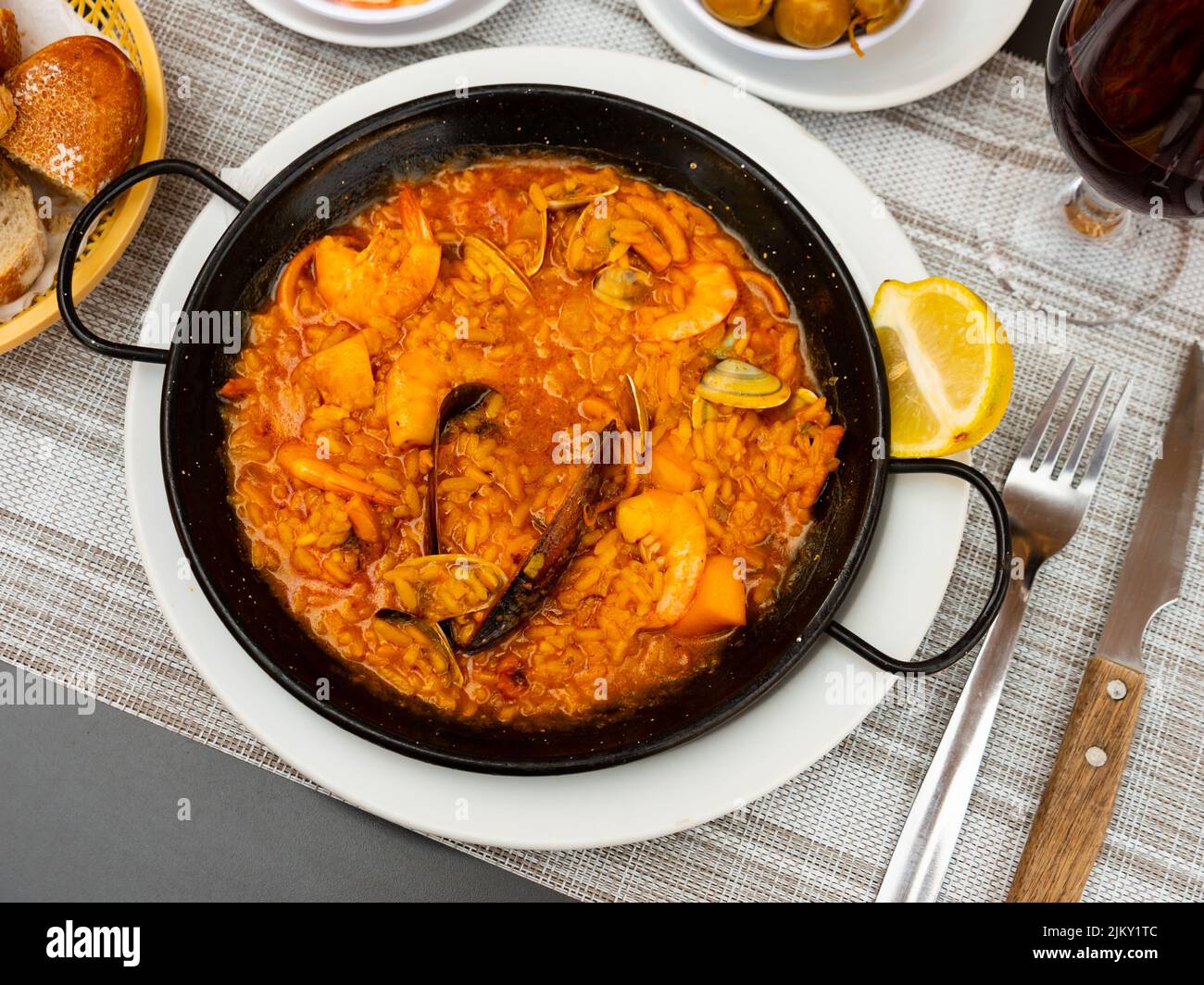 Traditional dish of Spanish cuisine is paella with seafood Stock Photo ...