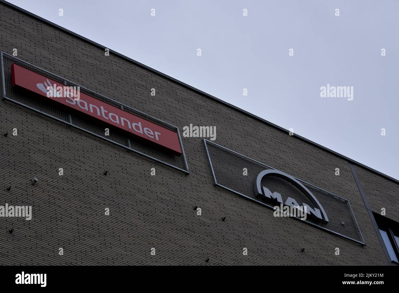 Santander bank and Man company logo on a brick wall of the Business ...