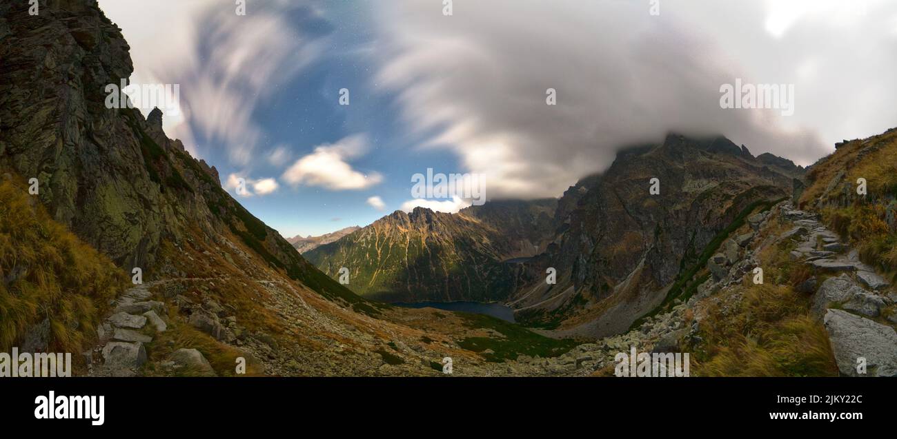 A long exposure shot of clouds above the mountains Stock Photo - Alamy