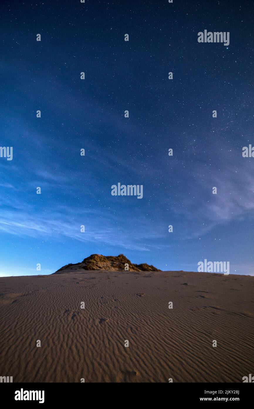 A vertical shot of a desert dune on a beautiful starry night sky Stock ...