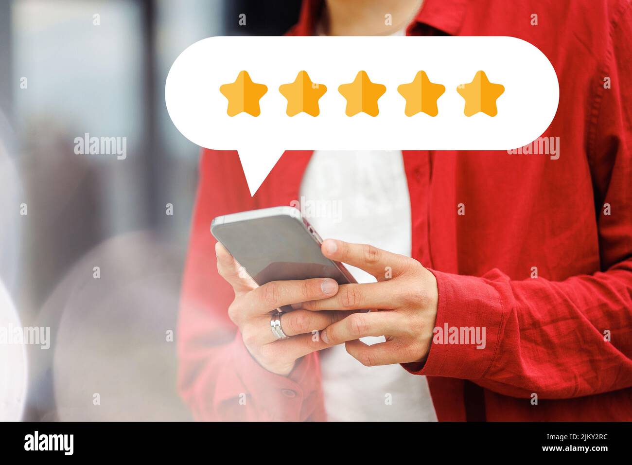 Young person giving a 5 star rating on mobile phone Stock Photo - Alamy