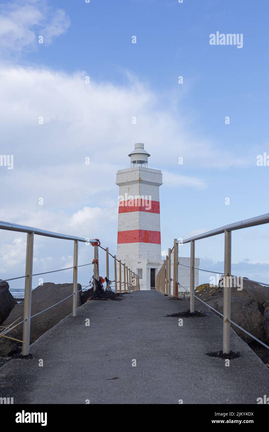 A vertical shot of the famous Gardur lighthouse on the coast of Iceland ...