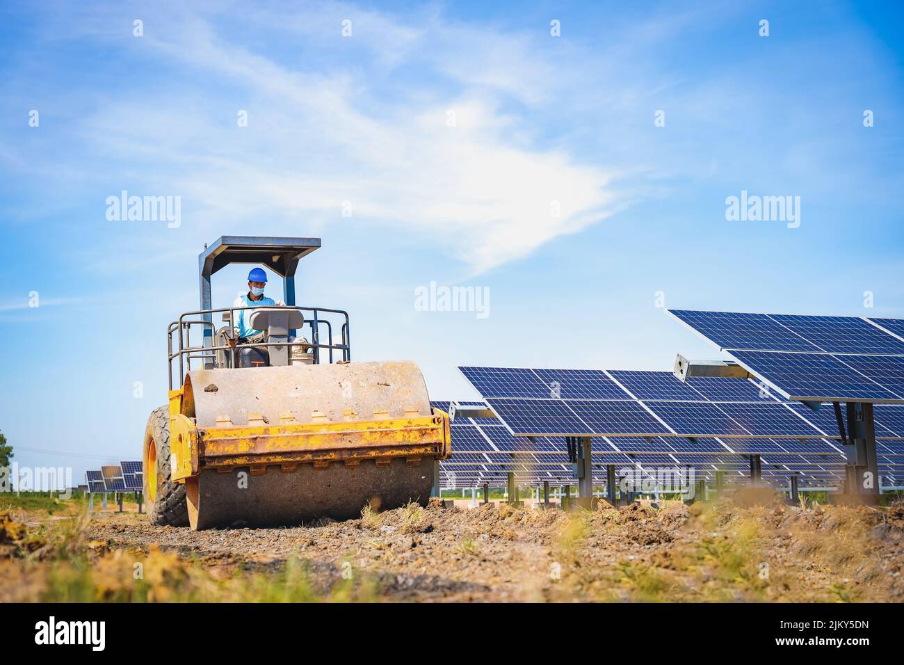 Soil compactor is working to compact the road to make the soil firm ...