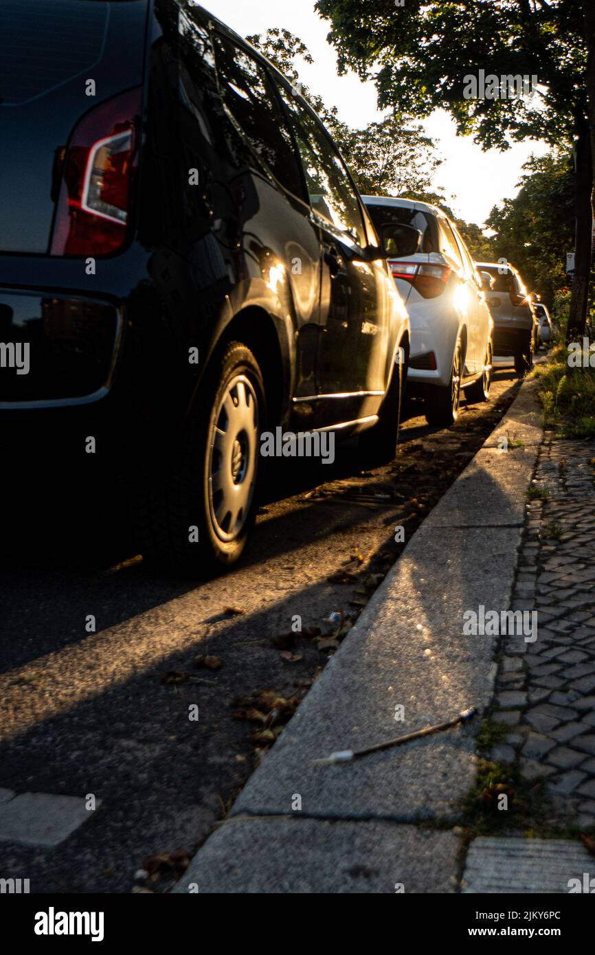 A vertical shot of cars parked on the side of the street Stock Photo ...
